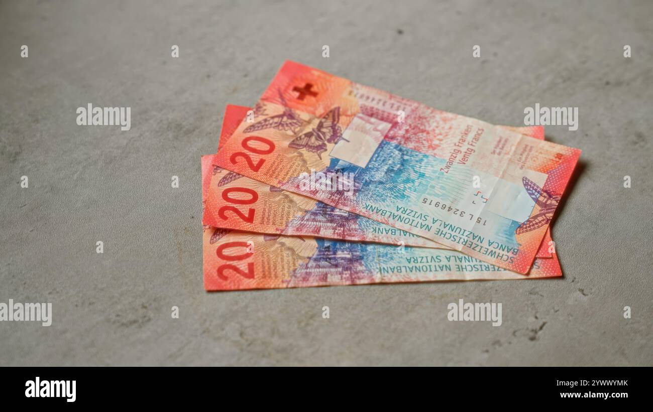 Swiss franc banknotes displayed on a concrete surface in switzerland ...