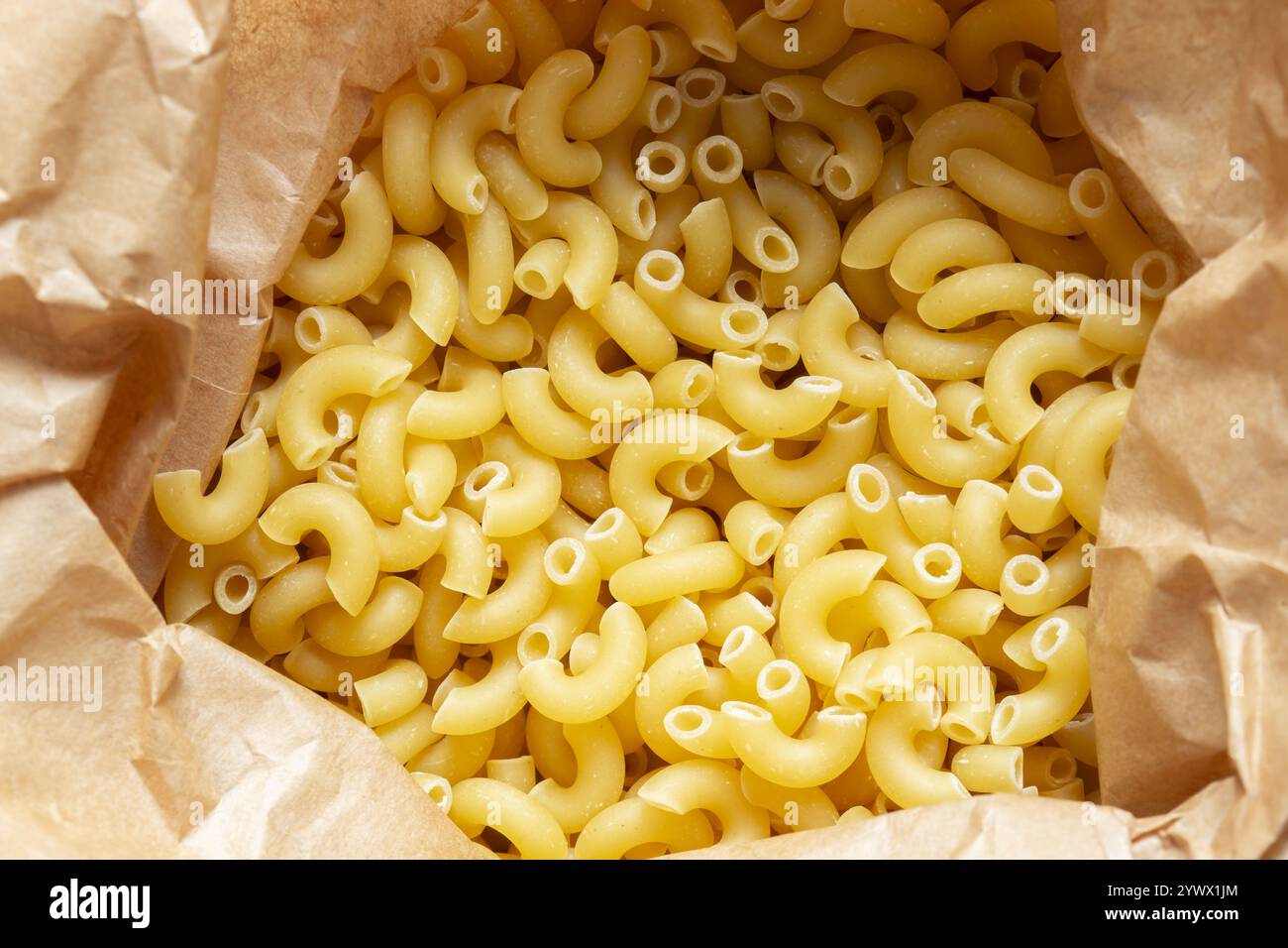Macaroni dried pasta in a brown paper bag. Eco-friendly recycling ...