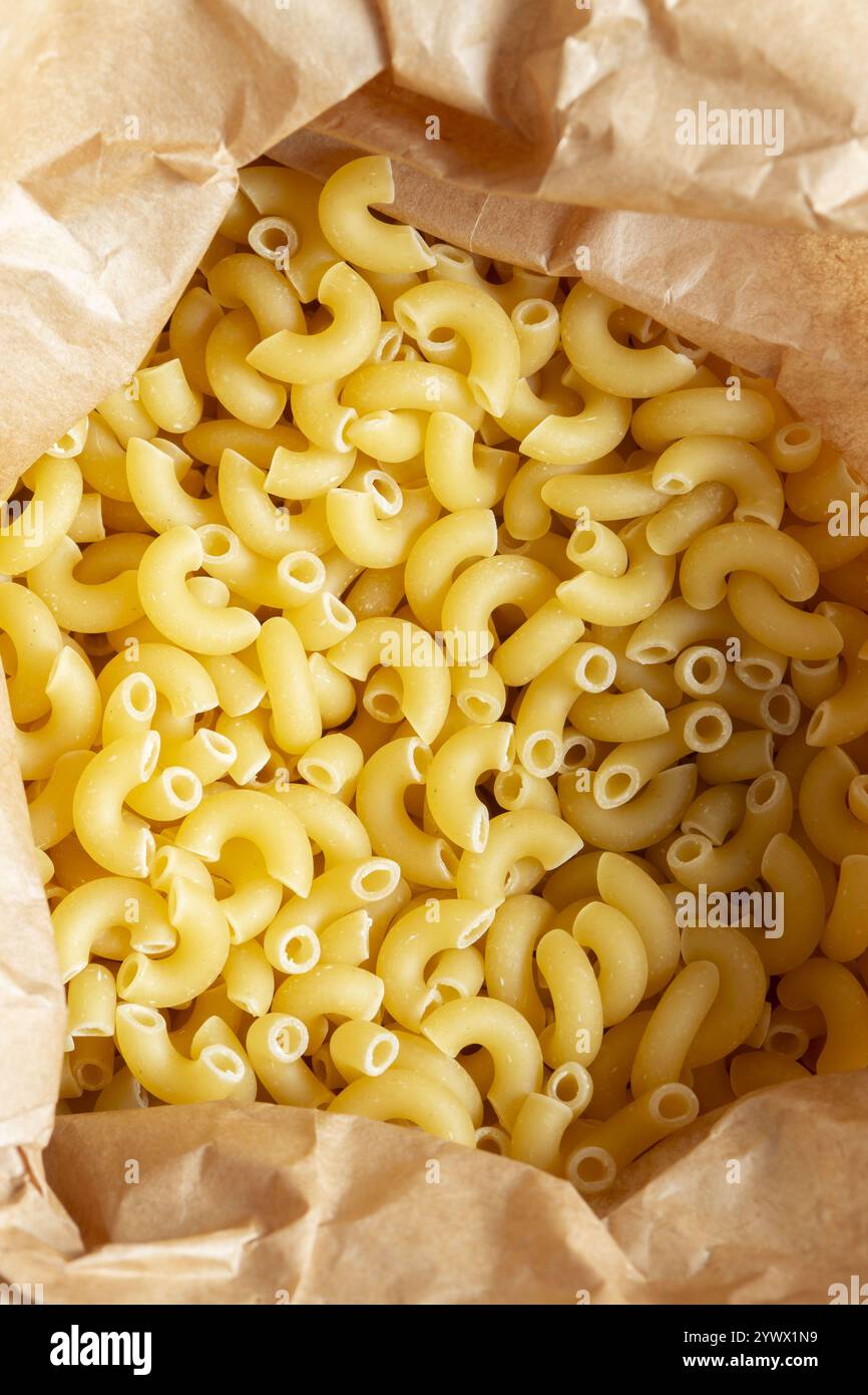 Macaroni dried pasta in a brown paper bag. Eco-friendly recycling ...