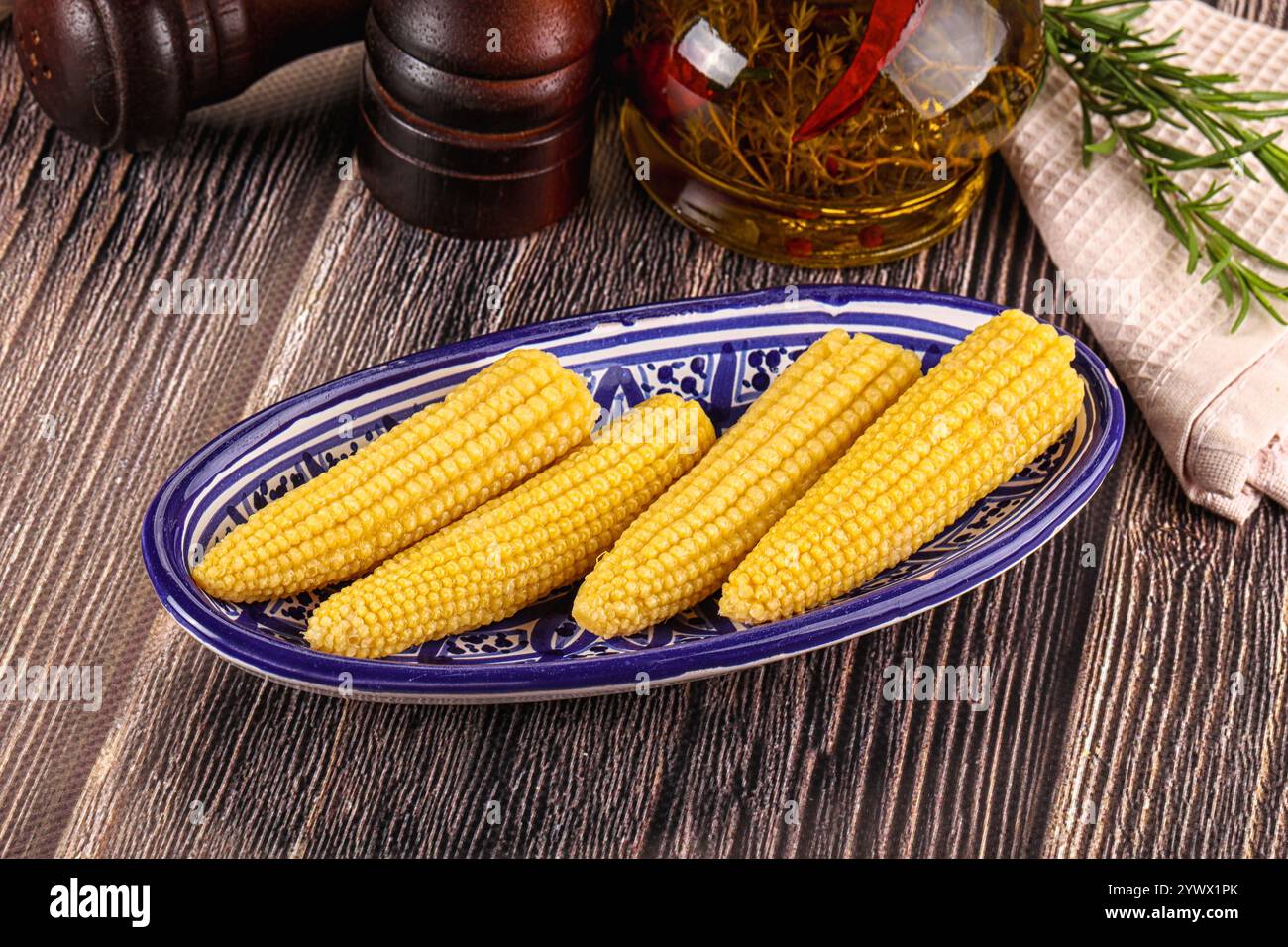 Canned baby mini corn cob in the plate Stock Photo - Alamy
