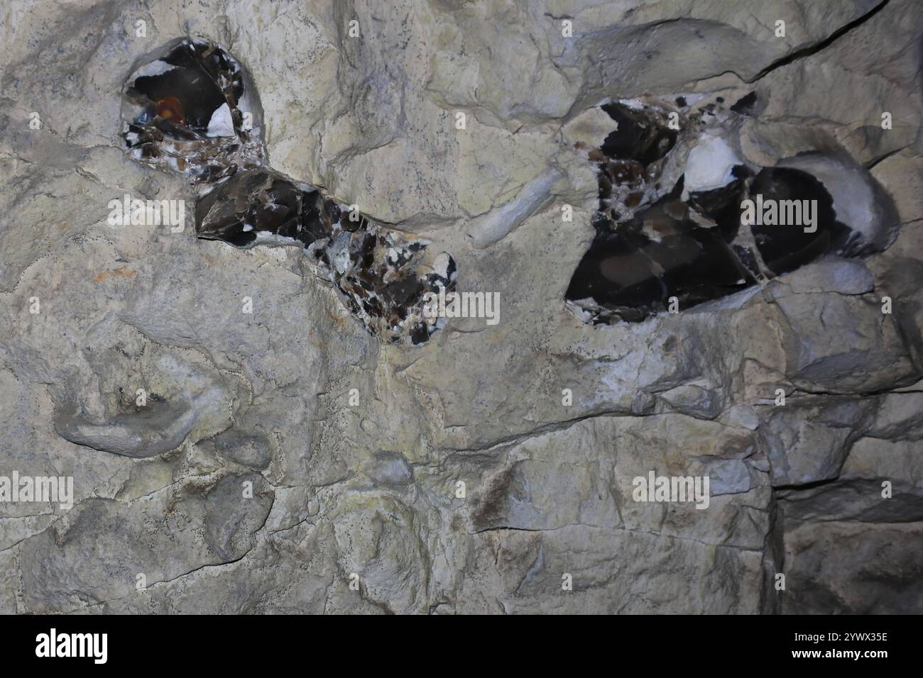 Background: A rock wall with with coloured stones, grey, black and ...