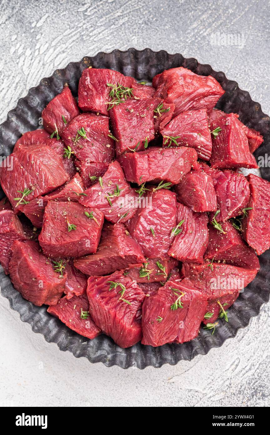 Ready for cooking Diced Raw kangaroo meat. white background. top view ...