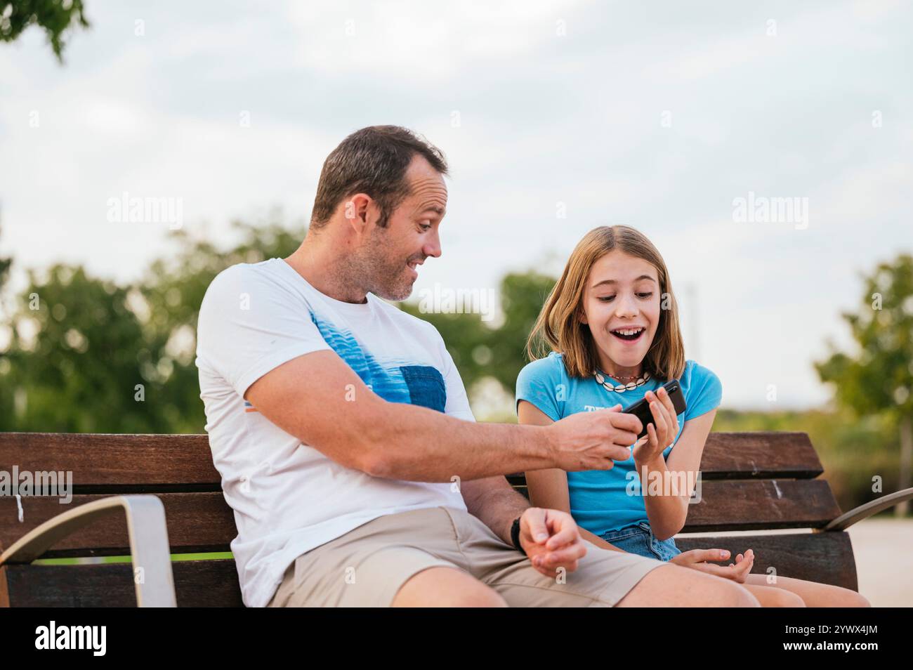 Father handing a smart phone to his little daughter Stock Photo - Alamy