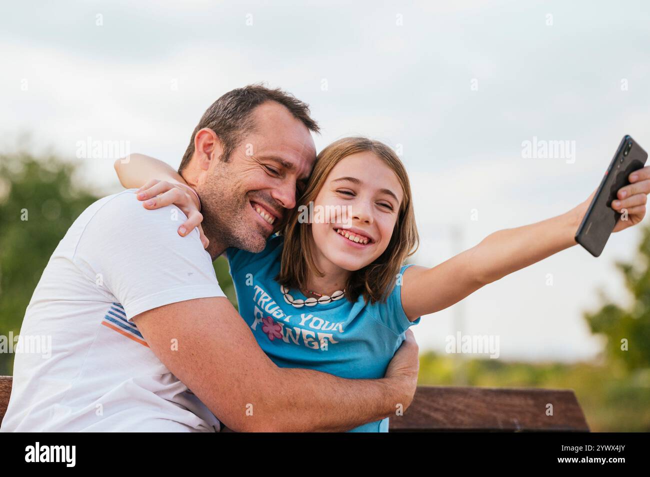 Father handing a smart phone to his little daughter Stock Photo - Alamy