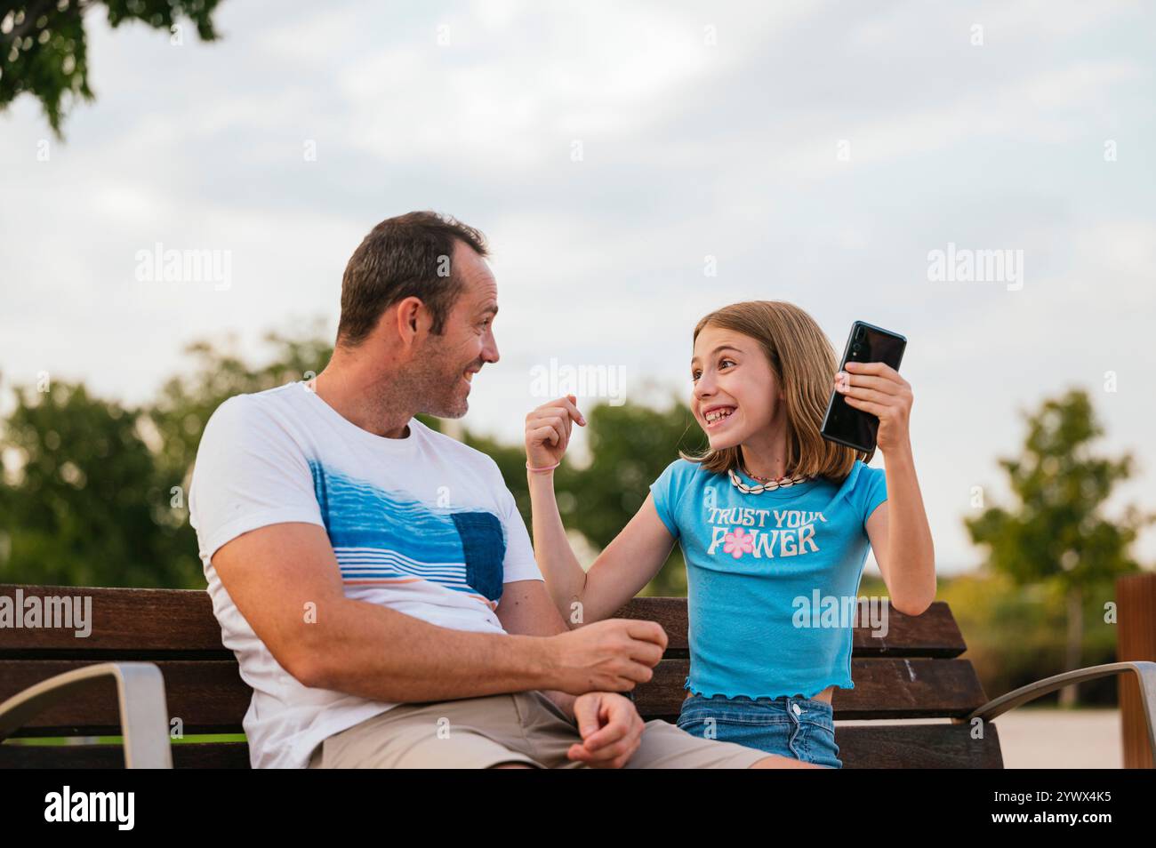 Father handing a smart phone to his little daughter Stock Photo - Alamy