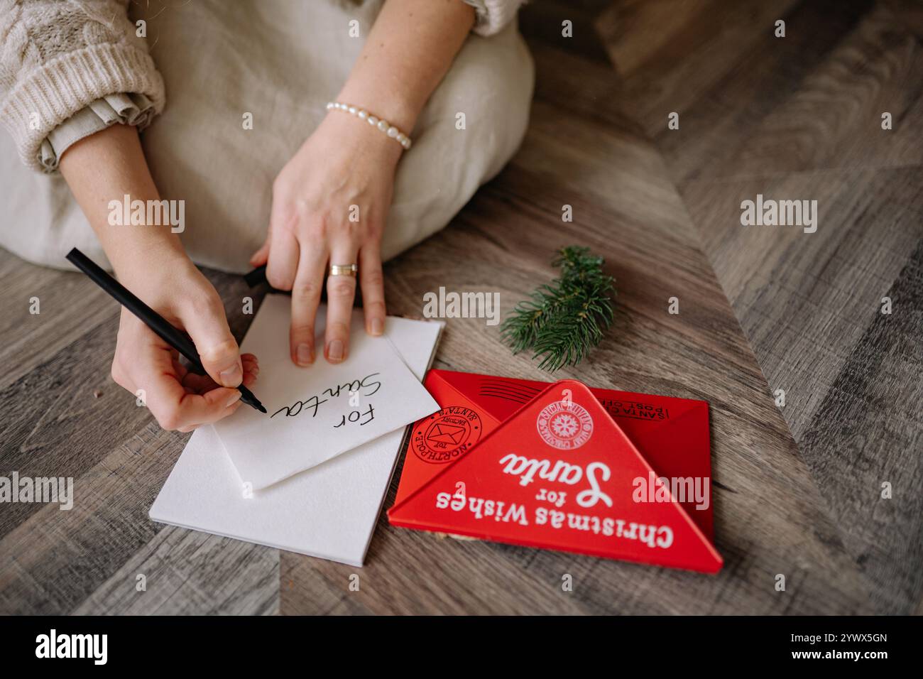 Writing heartfelt Christmas and New Year wishes in a cozy setting with ...