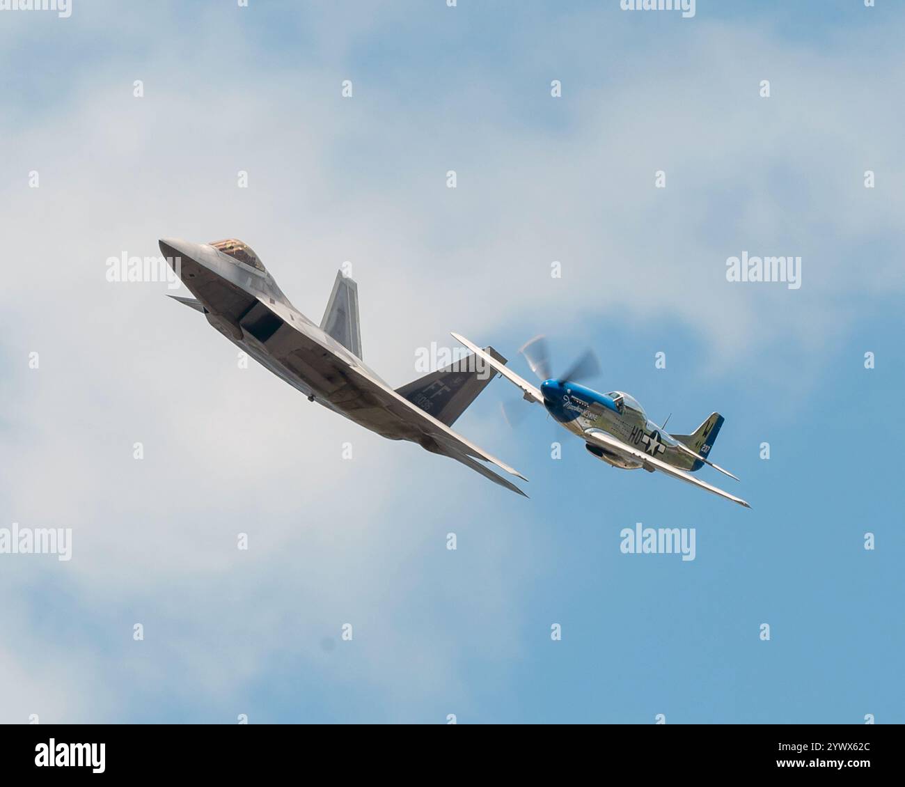 An F-22 Raptor and P-51 Mustang fly in formation at the 2023 Wings Over ...