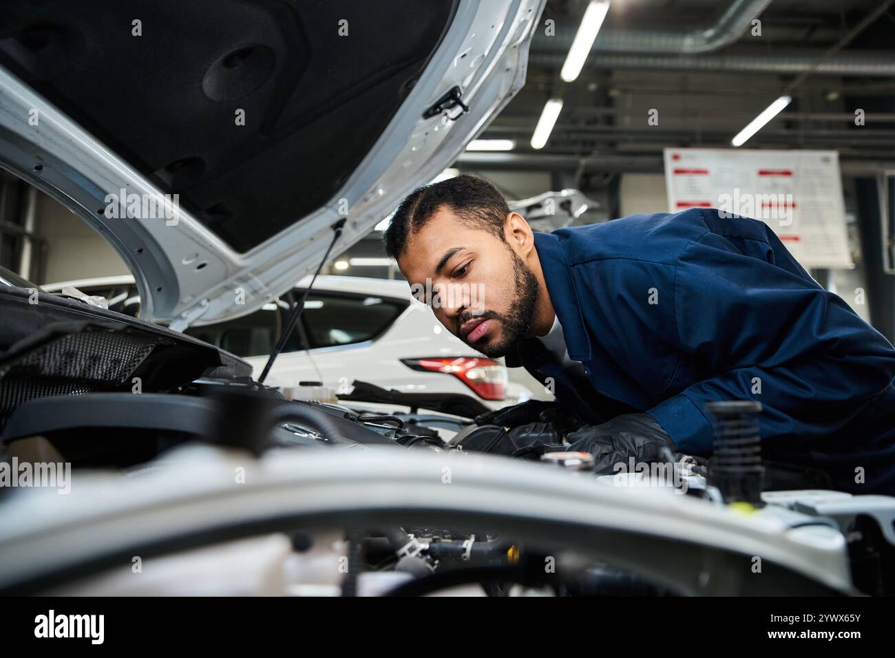 Young man examines engine hi-res stock photography and images - Alamy