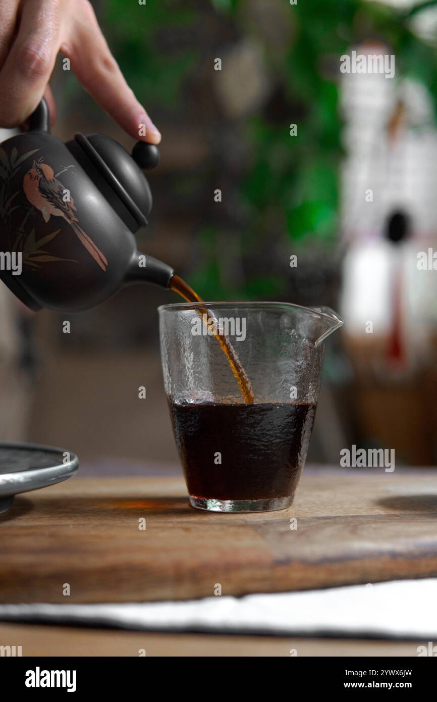 This is an Elegant Tea Pouring from a Stylish Teapot, creating a ...