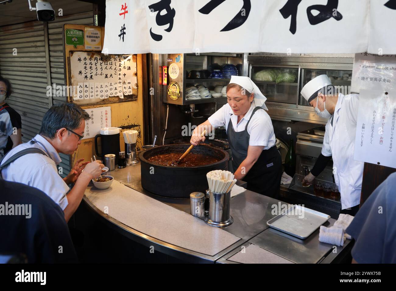 Woman serving beef stew in a roadside food stall in Outer Tsukiji ...