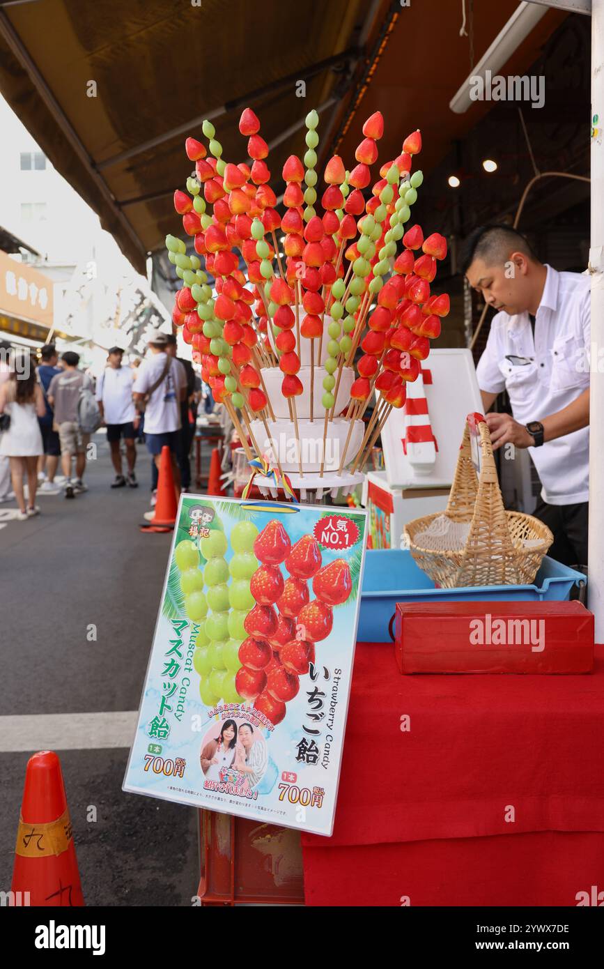 Colorful red candied strawberry sticks at the Tsukiji Outer Market in ...