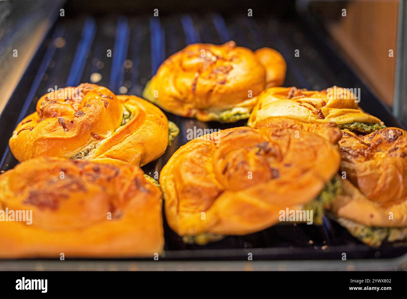hot delicious buns with greens on the counter in the bakery. Healthy ...