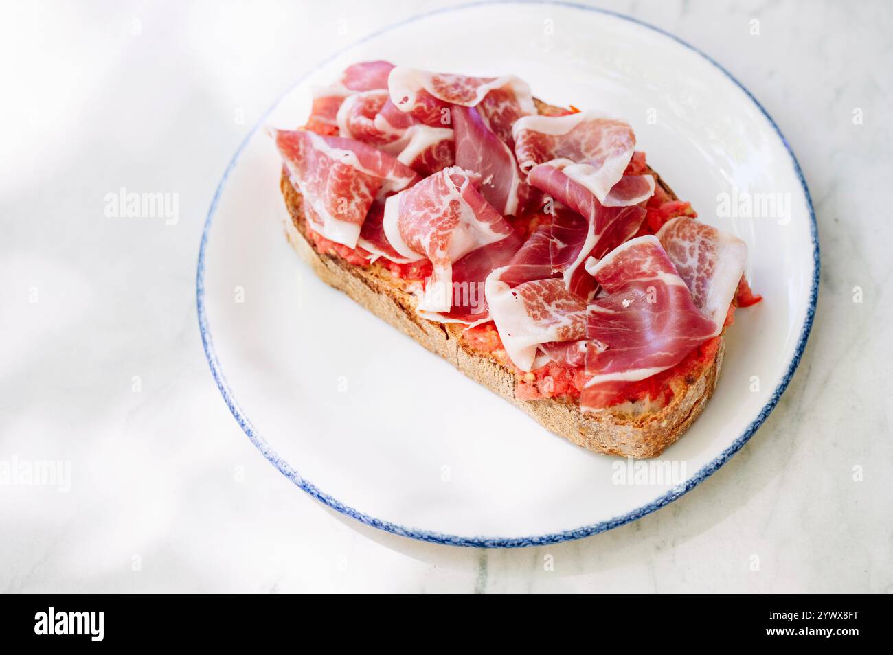Thinly sliced spanish ham hi-res stock photography and images - Alamy