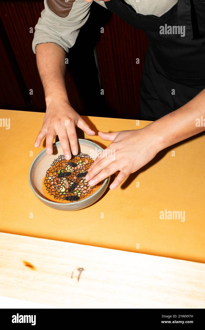 A chef's hands carefully placing a lattice topping over a soup Stock ...