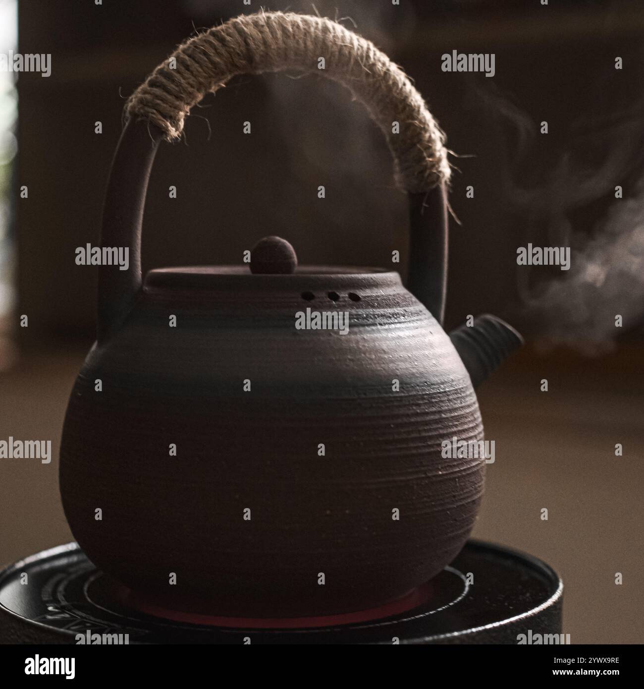 An Elegant Black Teapot with Steam Floating Above it on a Calm and ...