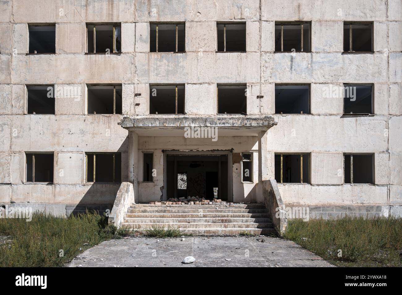 Entrance to an abandoned, destroyed residential building, old Soviet ...