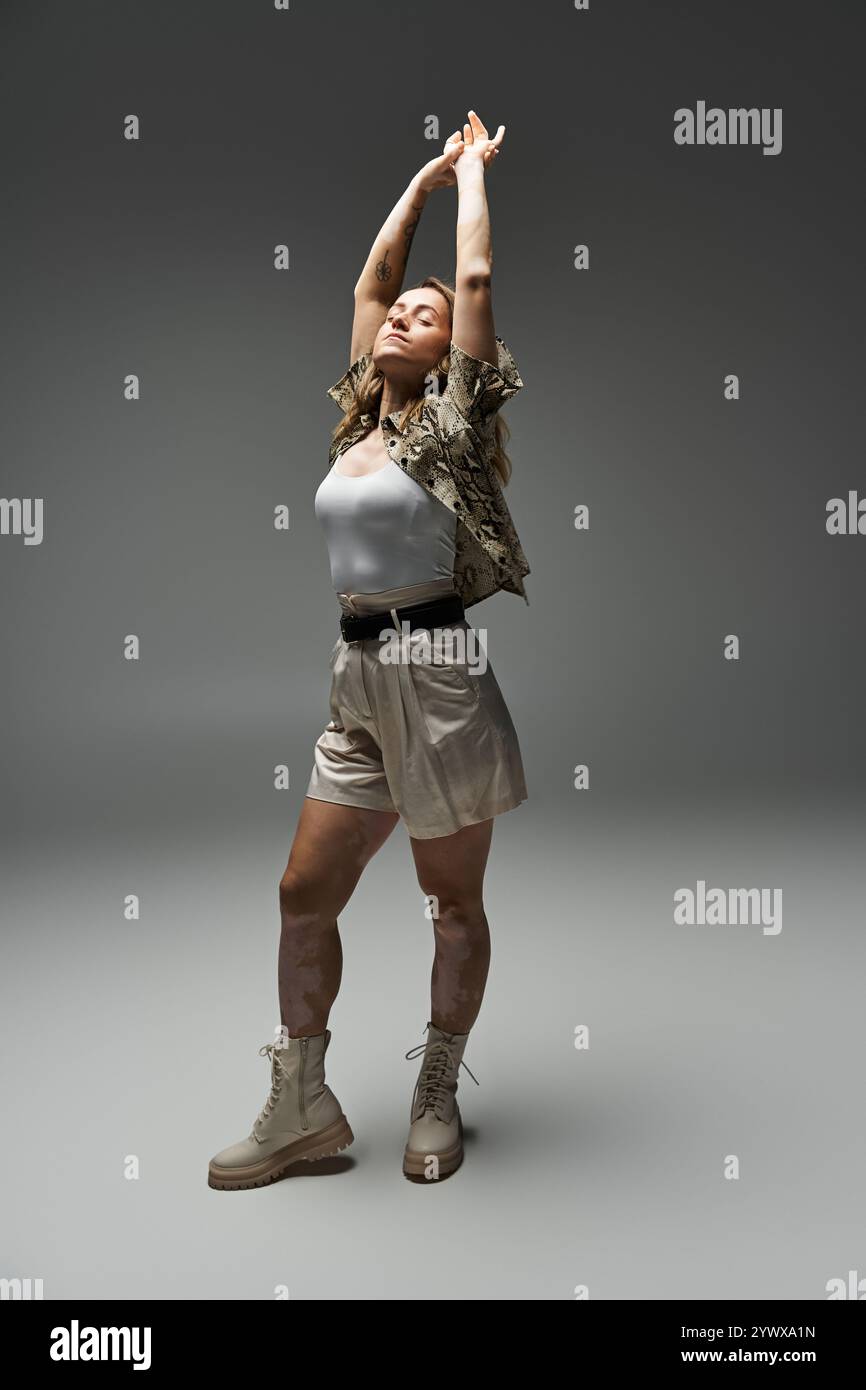 Young woman stretches and poses in stylish outfit showcasing her ...