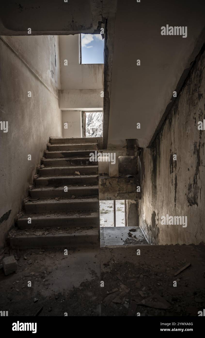 Abandoned destroyed staircase in a residential building, Soviet ...