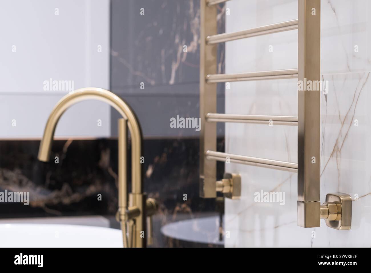 gold-colored heating radiator on a granite wall in the bathroom Stock ...