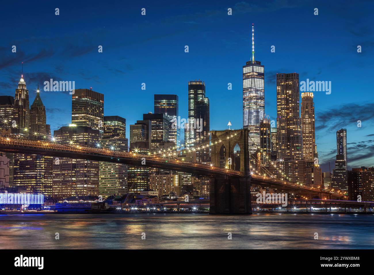 The photo captures the Brooklyn Bridge at night from Brooklyn, with ...
