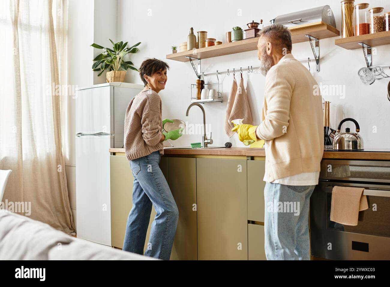 A mature couple cooks together, creating a warm, loving atmosphere in ...