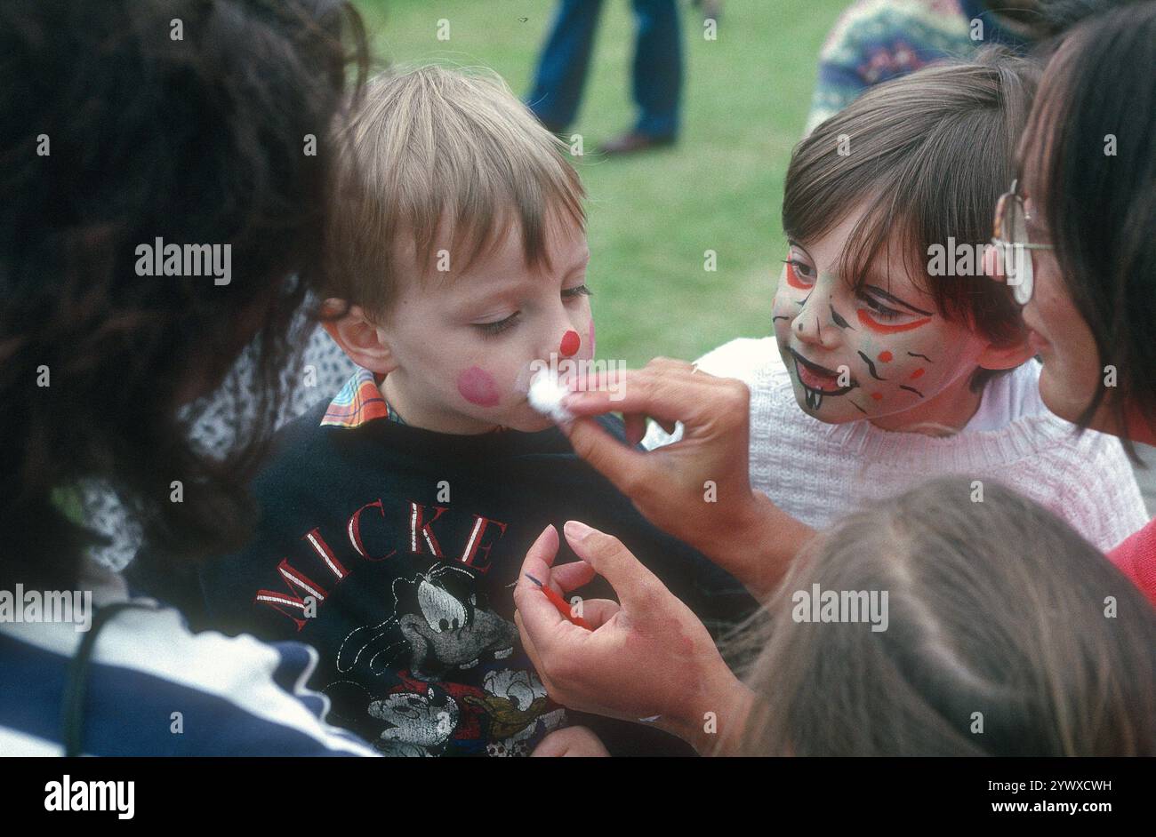 A primary school pupil having face makeup for a Parent Teacher day out ...