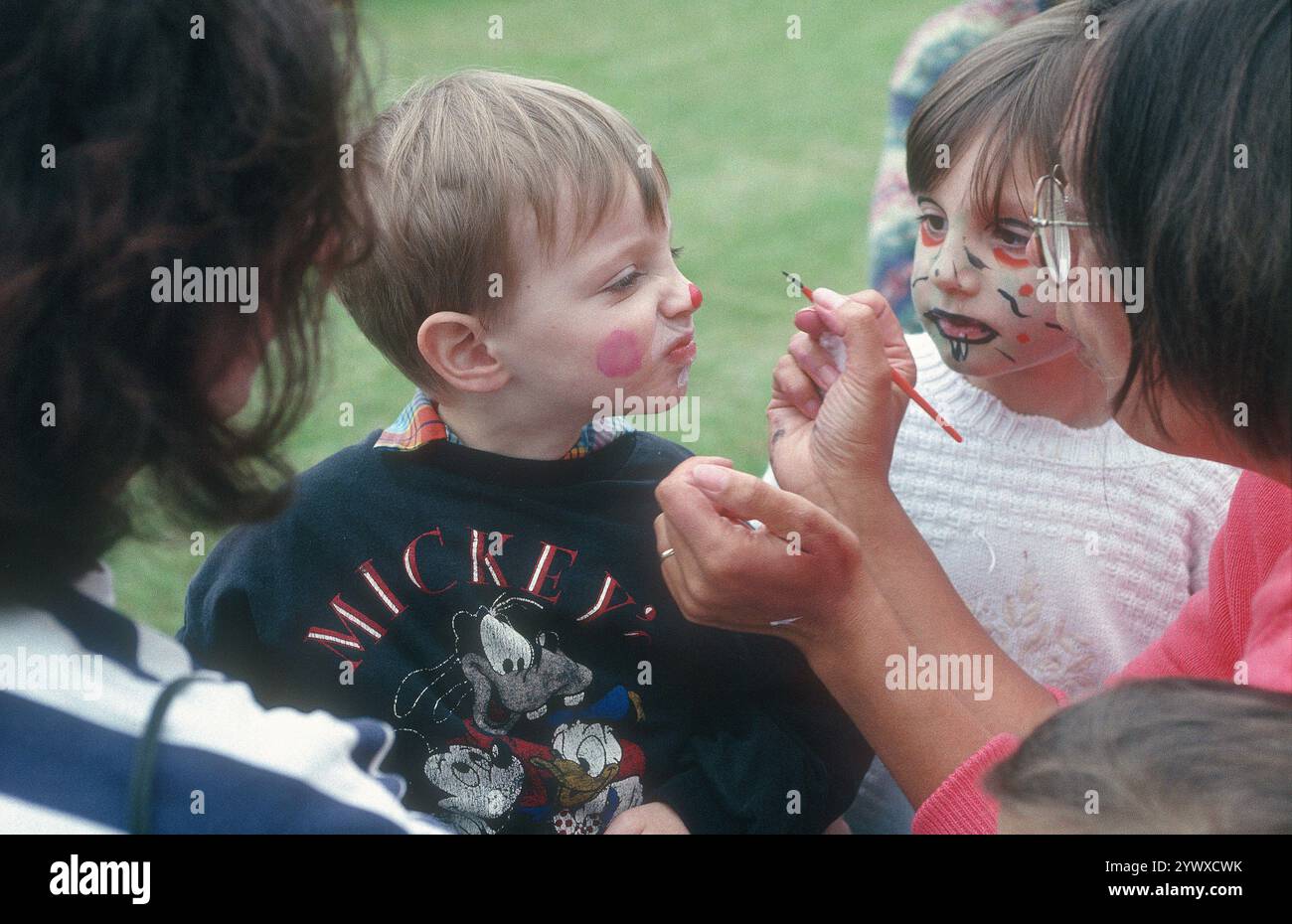 A primary school pupil having face makeup for a Parent Teacher day out ...