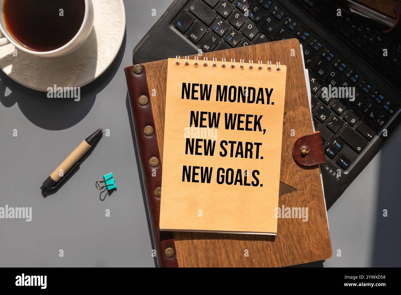 Gold bar and banknotes with text New Monday New week New Goal on a blue ...