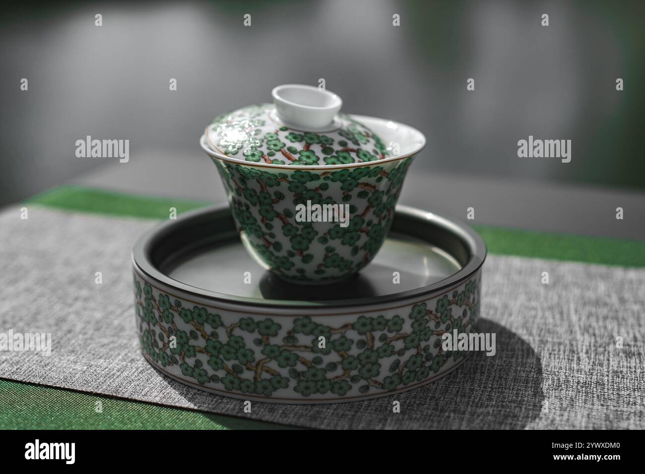 A beautifully crafted Elegant Green Floral Teapot complemented by a ...