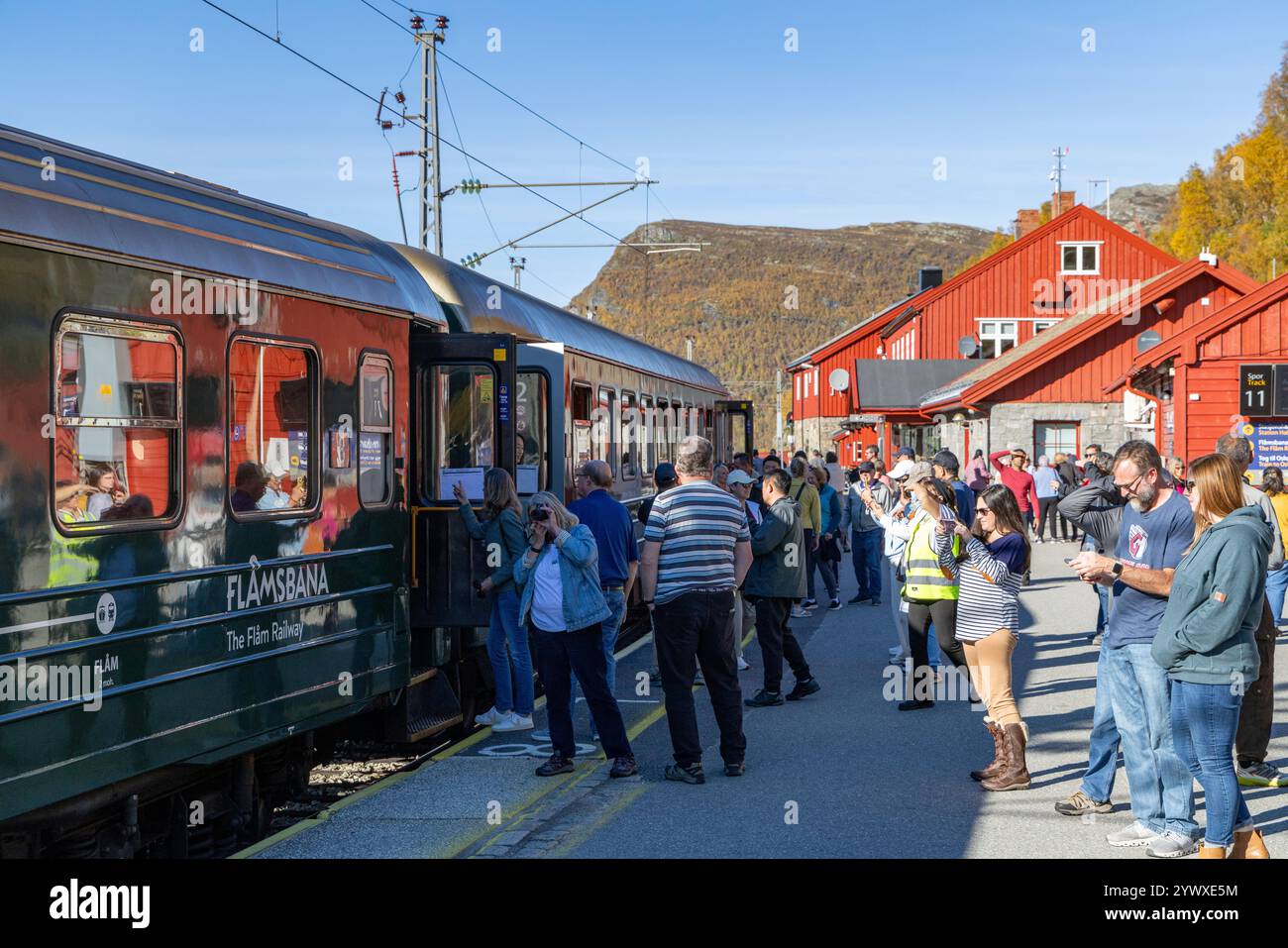 Flam railway train at Myrdal train station with tourists boarding the train for the journey to ...