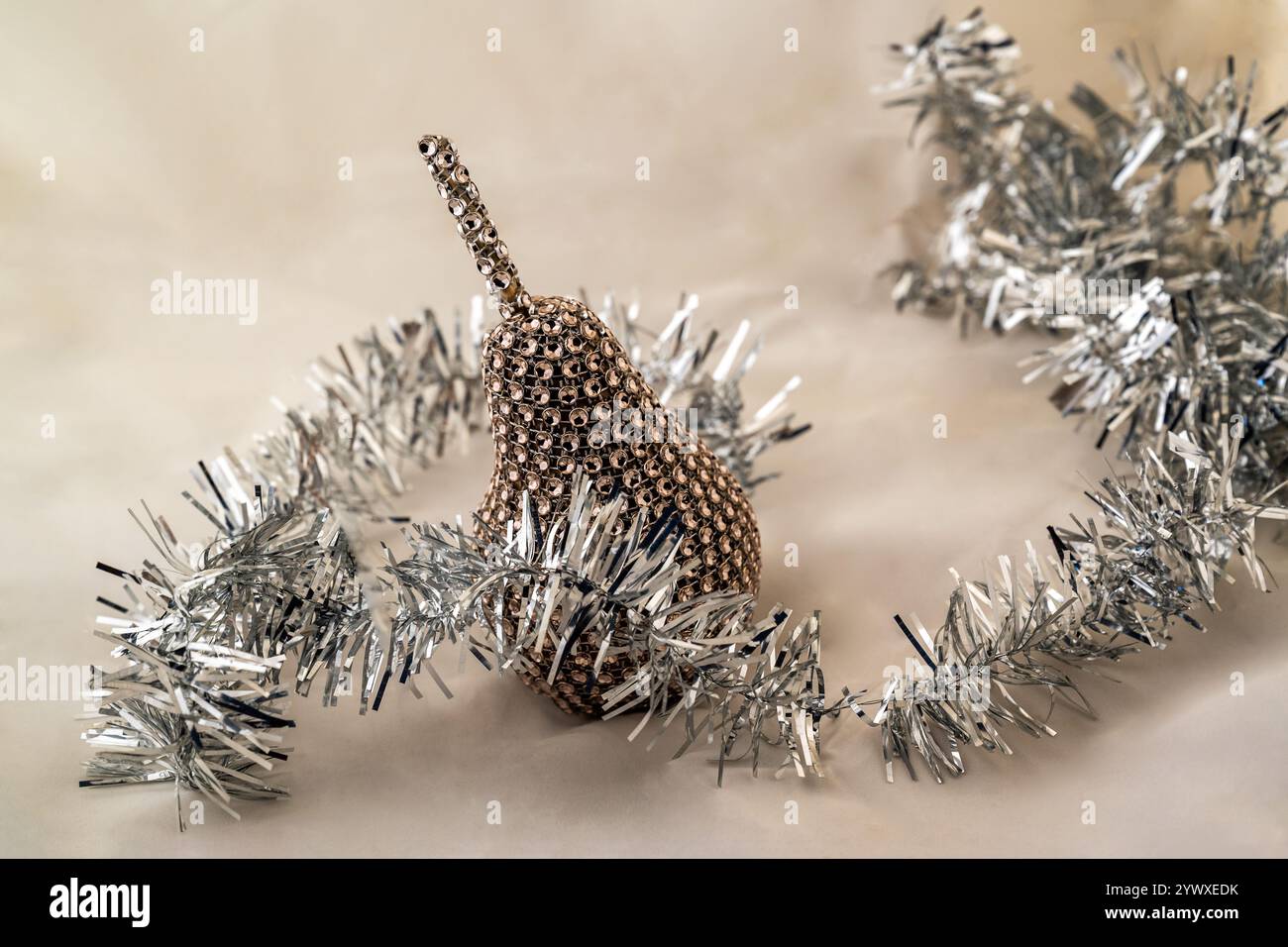Decorative golden metallic pear and silver Christmas chain, still life ...