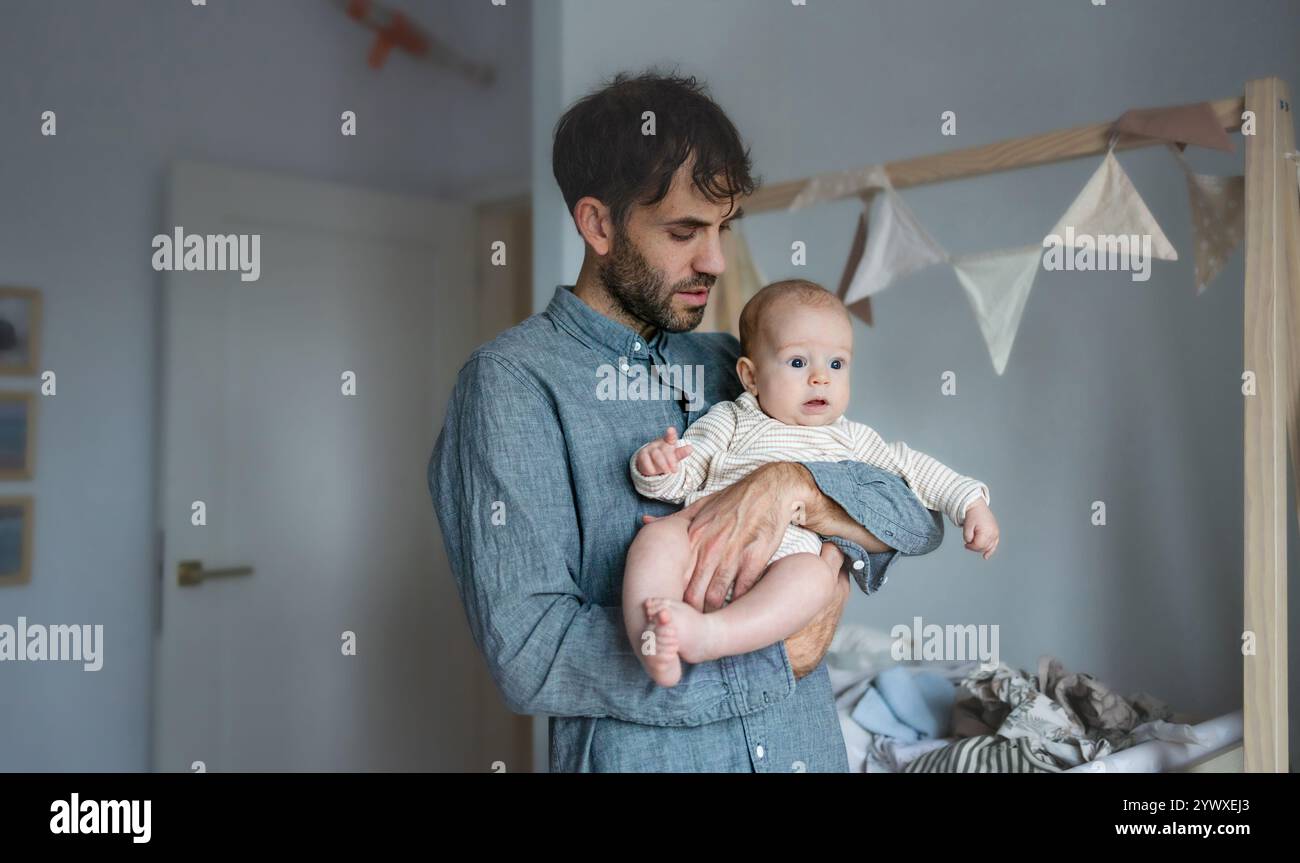 Father on paternity leave looking after his infant son at home Stock ...
