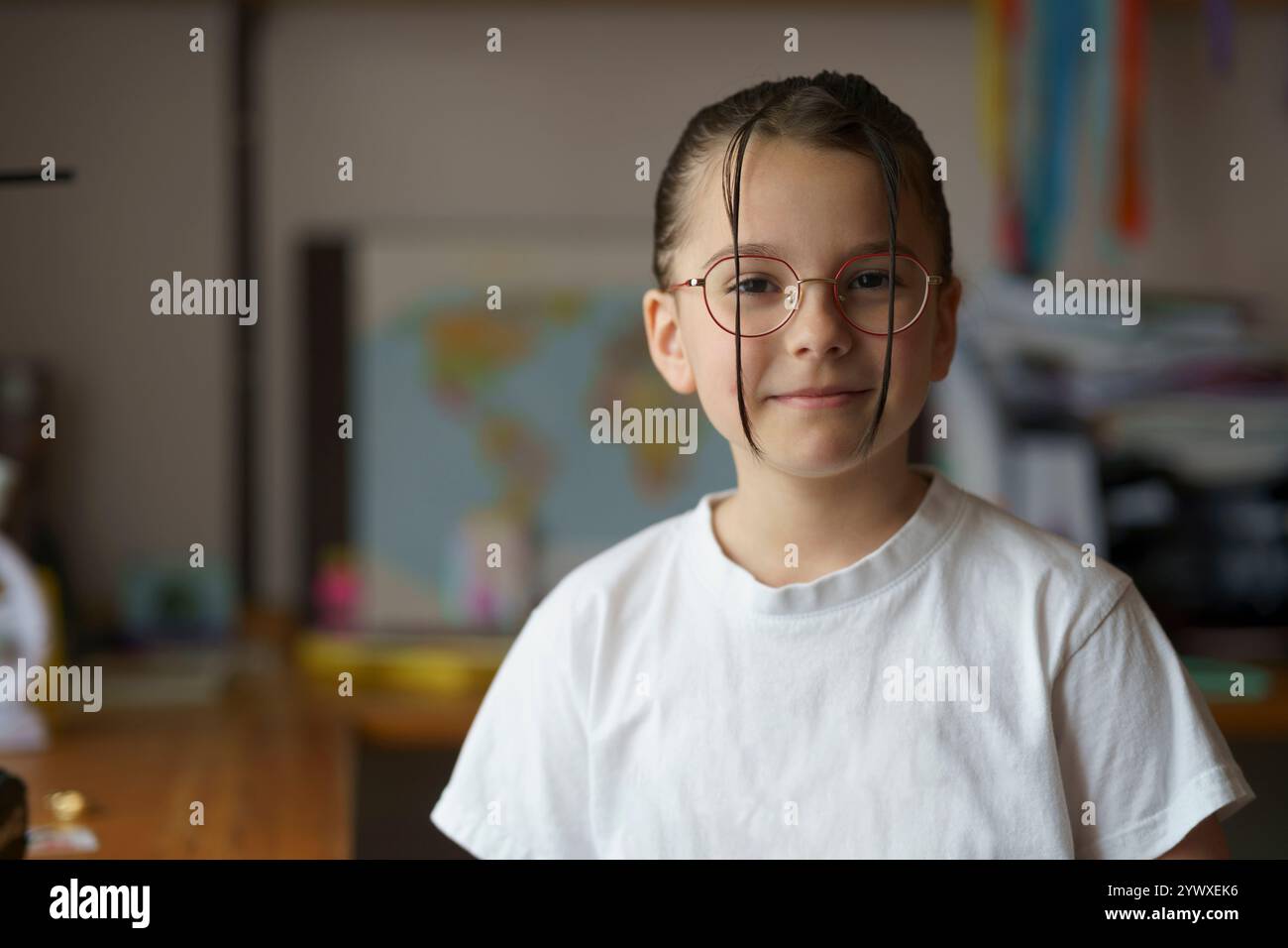 Little beautiful teenage girl in glasses with a hairstyle. Blurred ...