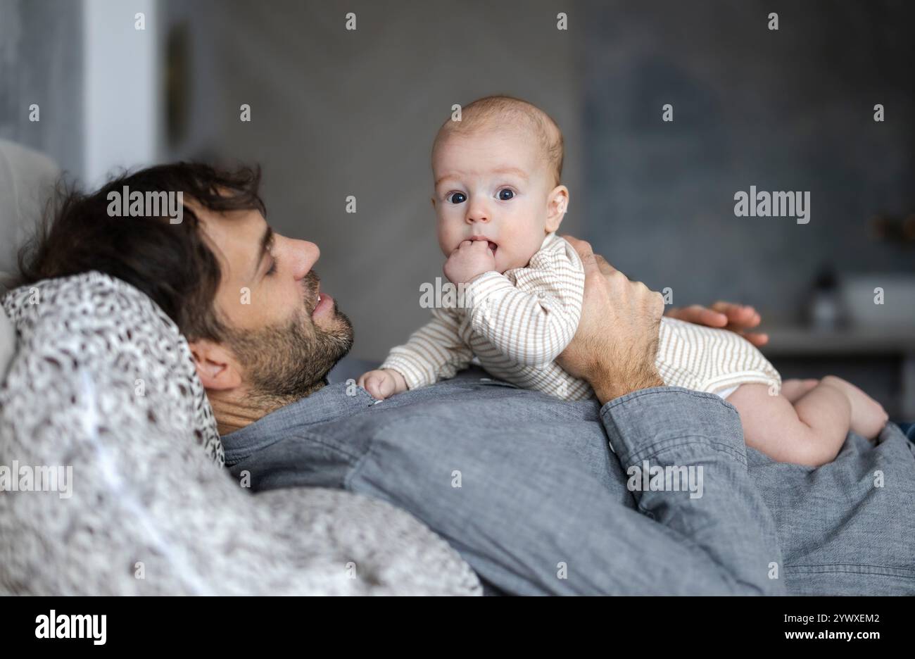 Father on paternity leave looking after his infant son at home Stock ...