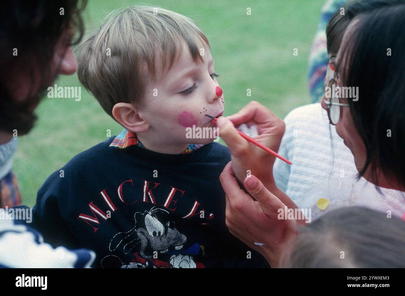 A primary school pupil having face makeup for a Parent Teacher day out ...