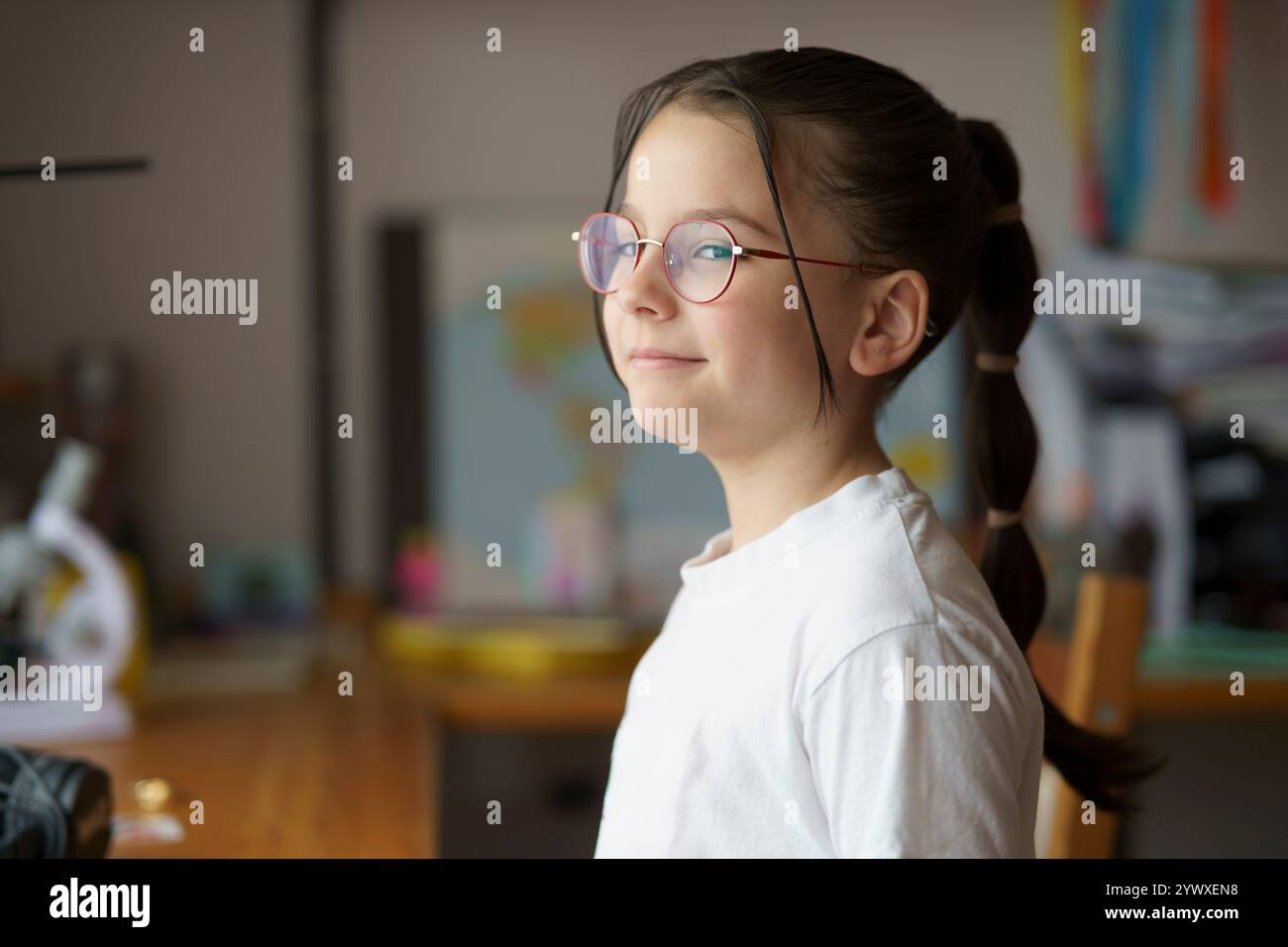 Little beautiful teenage girl in glasses with a hairstyle. Blurred ...