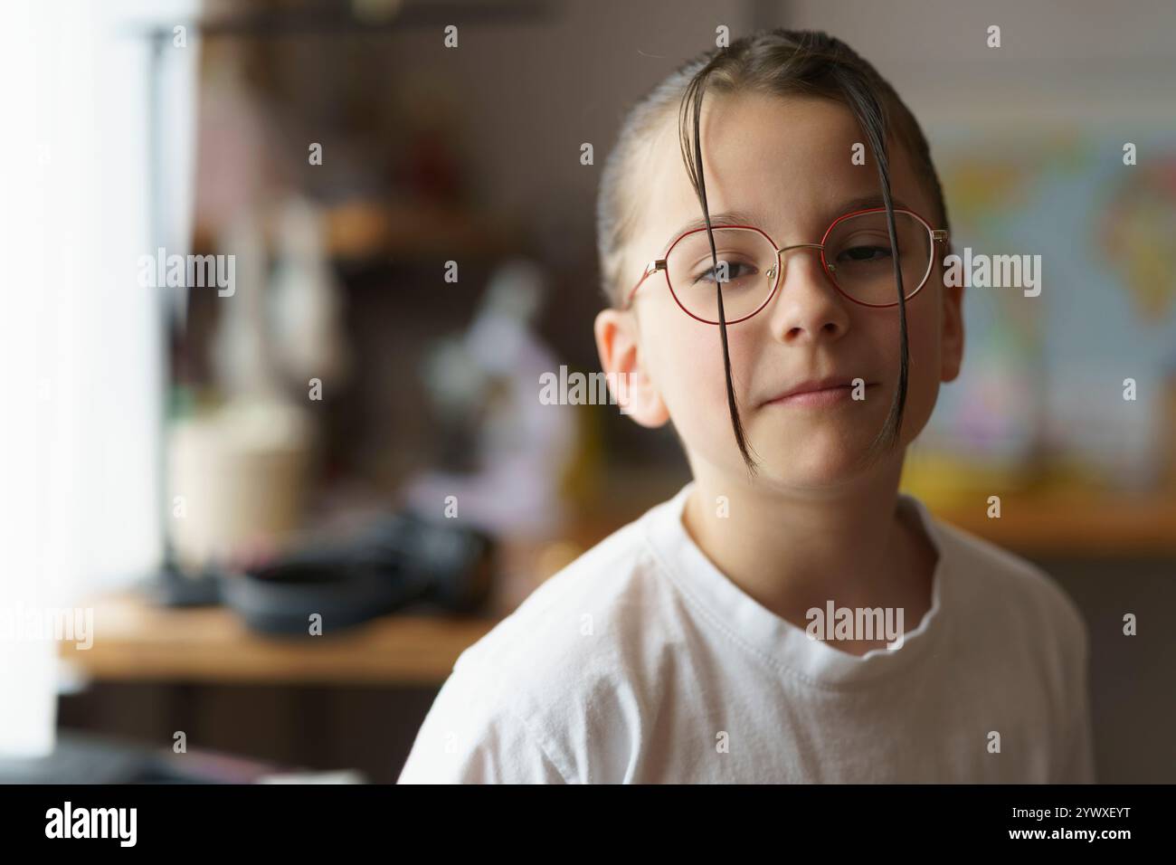 Little beautiful teenage girl in glasses with a hairstyle. Blurred ...