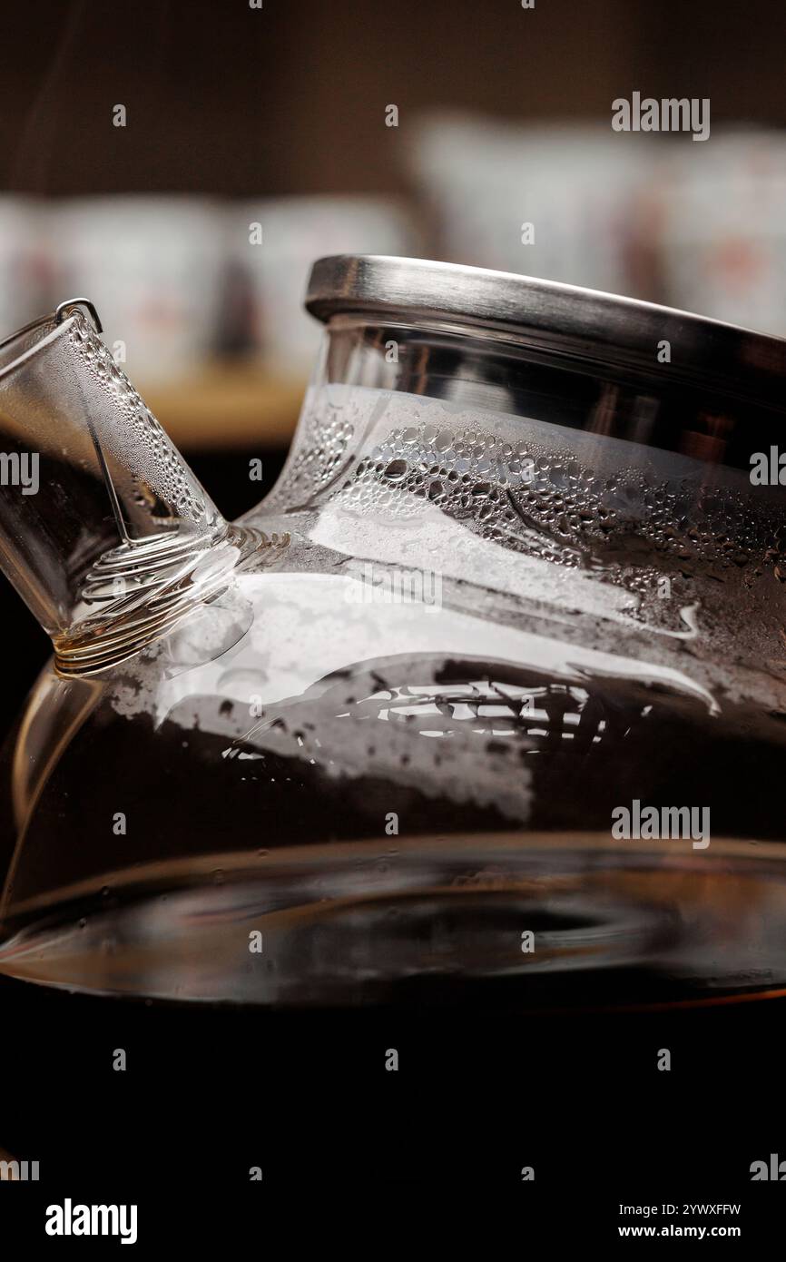 An Elegant Glass Teapot featuring Steam and Beautiful Reflections that ...