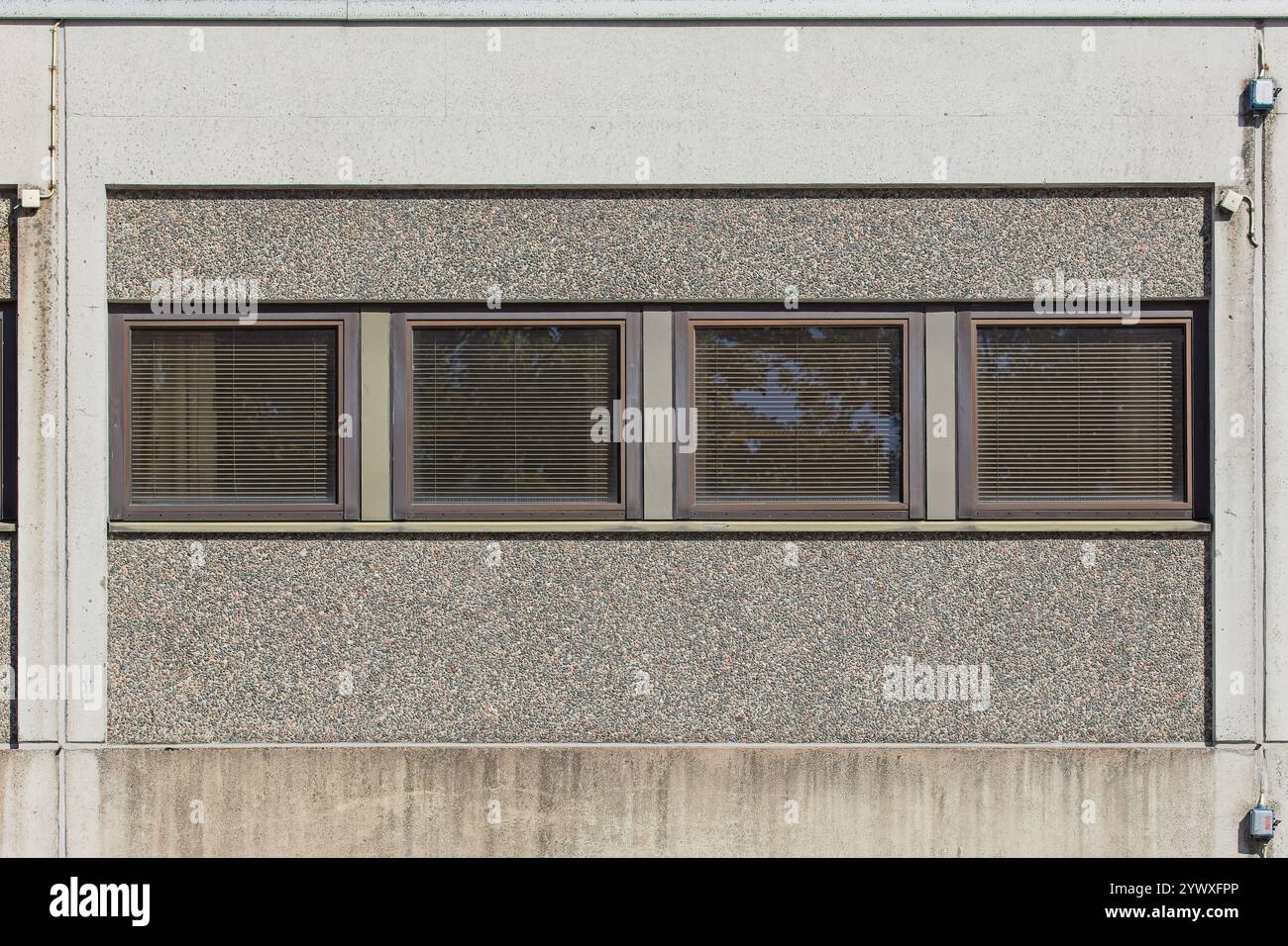 Windows with shades on a concrete wall Stock Photo - Alamy