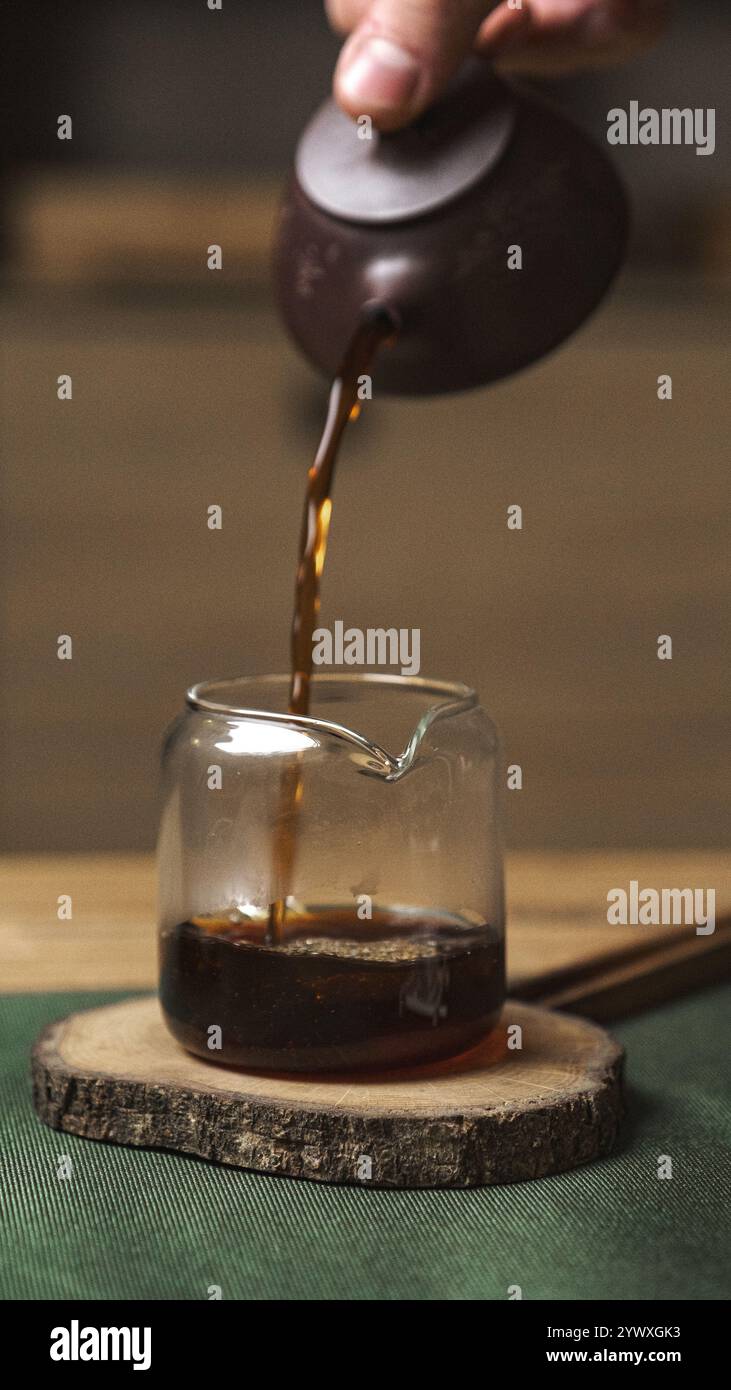 Gently Pouring Tea from a Beautifully Crafted Traditional Teapot into a ...