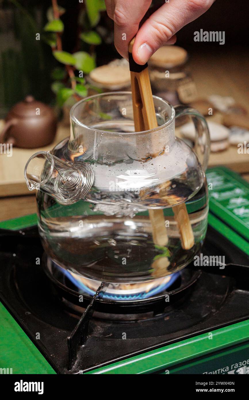 Boiling water with traditional ceramics in a warm and cozy kitchen is a ...
