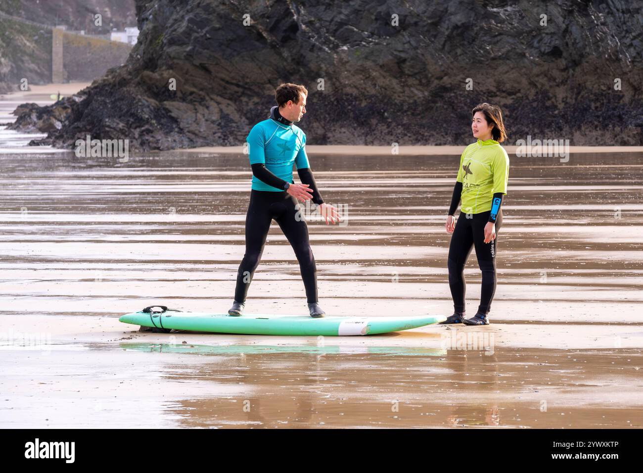 A surfing instructor explaining tecnique to a beginner on Towan Beach ...