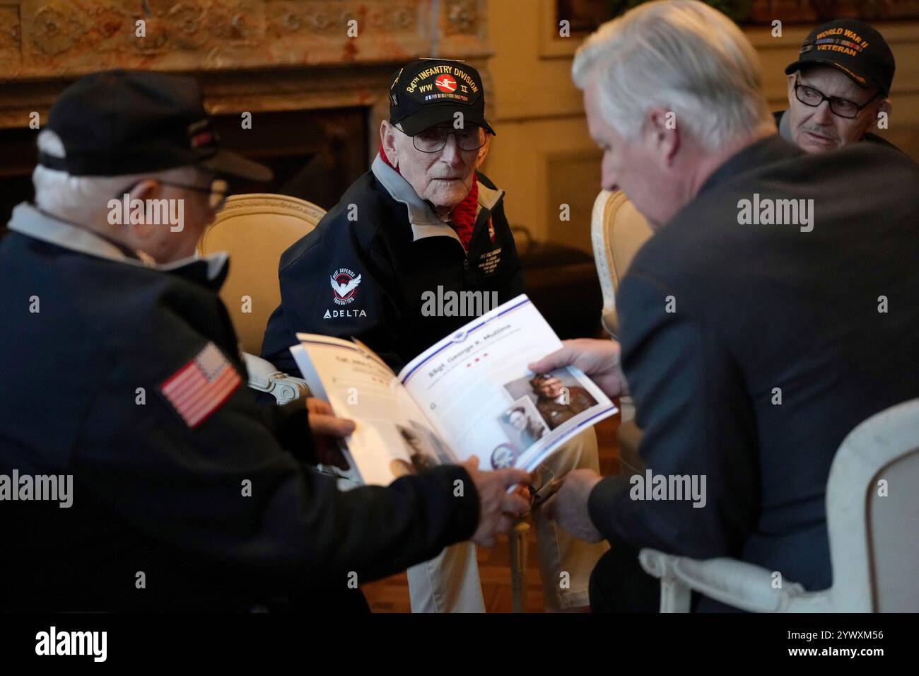 Belgium's King Philippe, second right, speaks with World War II ...