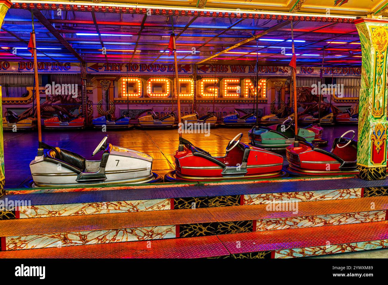 Rows of Vintage ‘Dodgem Cars’ Parked Under Colourful Lights Waiting For Drivers at a Popular ...