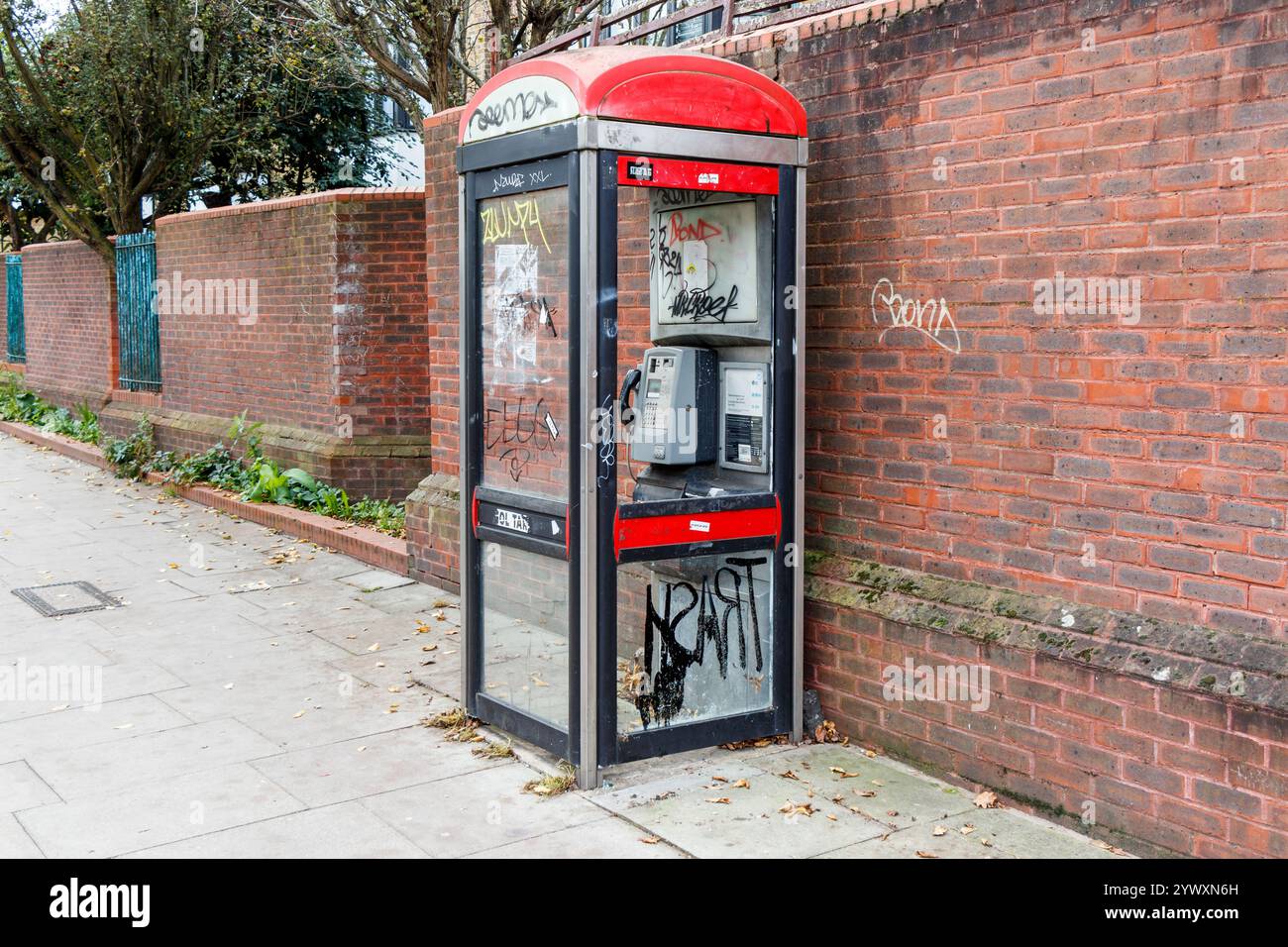 A BT public telephone box, covered with graffiti, in Junction Road ...