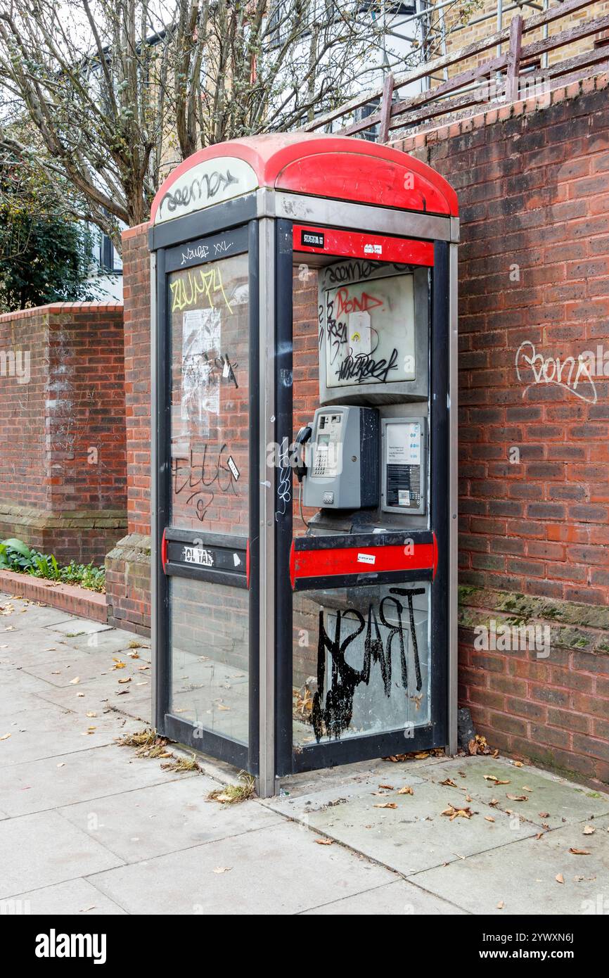 A BT public telephone box, covered with graffiti, in Junction Road ...
