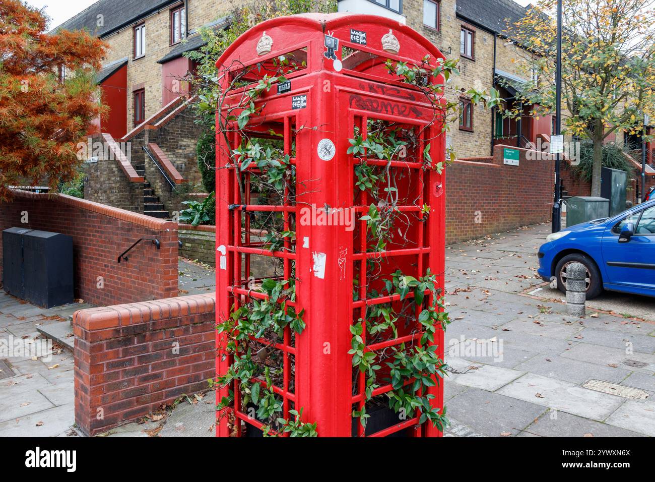 A red K6 telephone box (designed by Sir Giles Gilbert Scott in 1935), now non-functional, filled ...