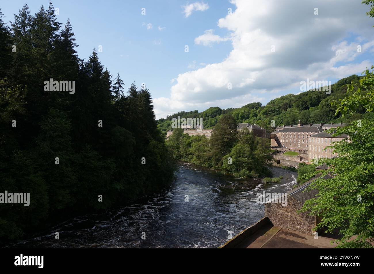 A view of a river, trees and old buildings, New Lanark World Heritage ...