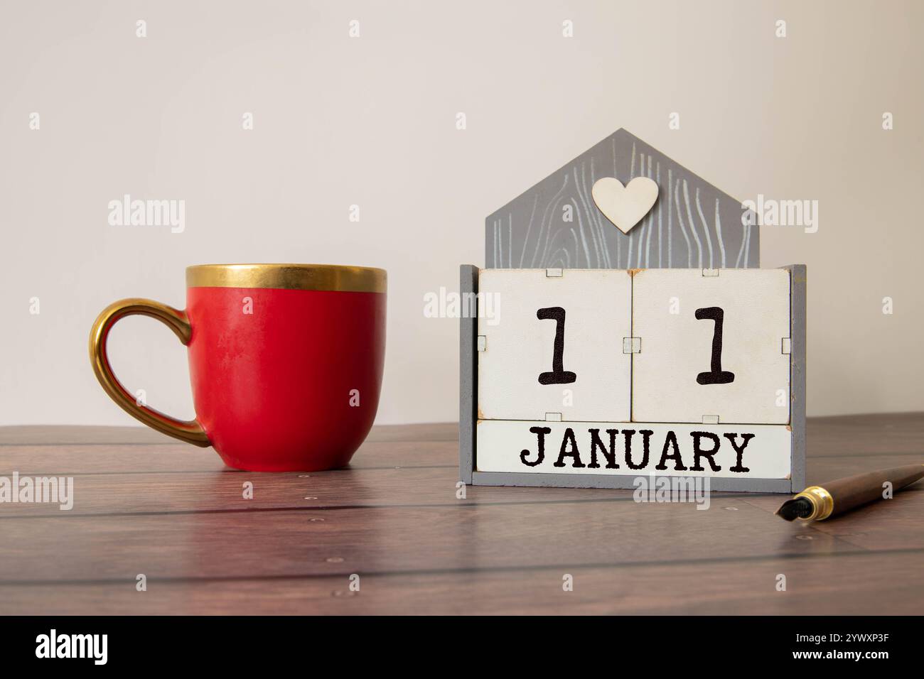 Wooden calendar, a set of dates of the month 11 January, on a white and ...