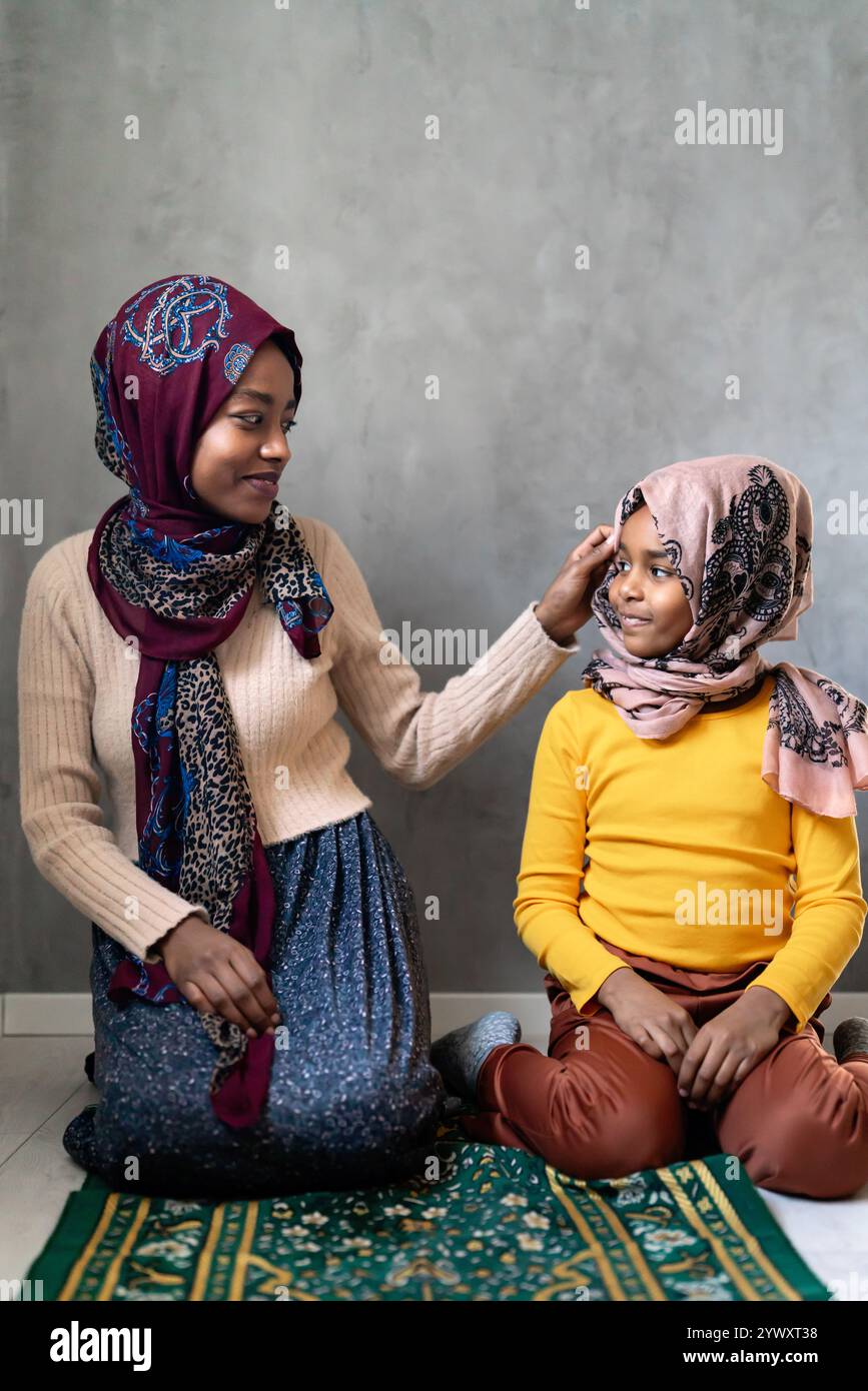 Muslim family praying together. Religious activity concept Stock Photo ...